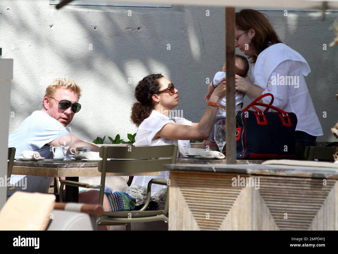 Tennis ace Boris Becker walks along Miami Beach boardwalk yawning and ...