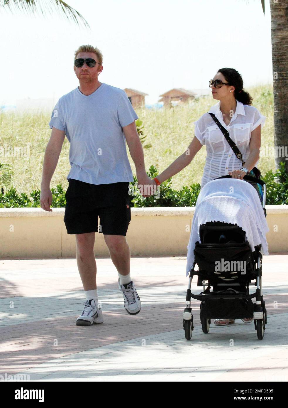 Tennis ace Boris Becker walks along Miami Beach boardwalk yawning and ...