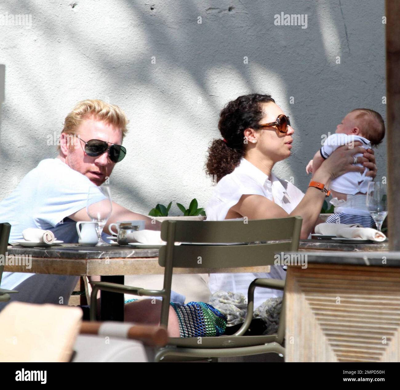 Tennis ace Boris Becker walks along Miami Beach boardwalk yawning and ...