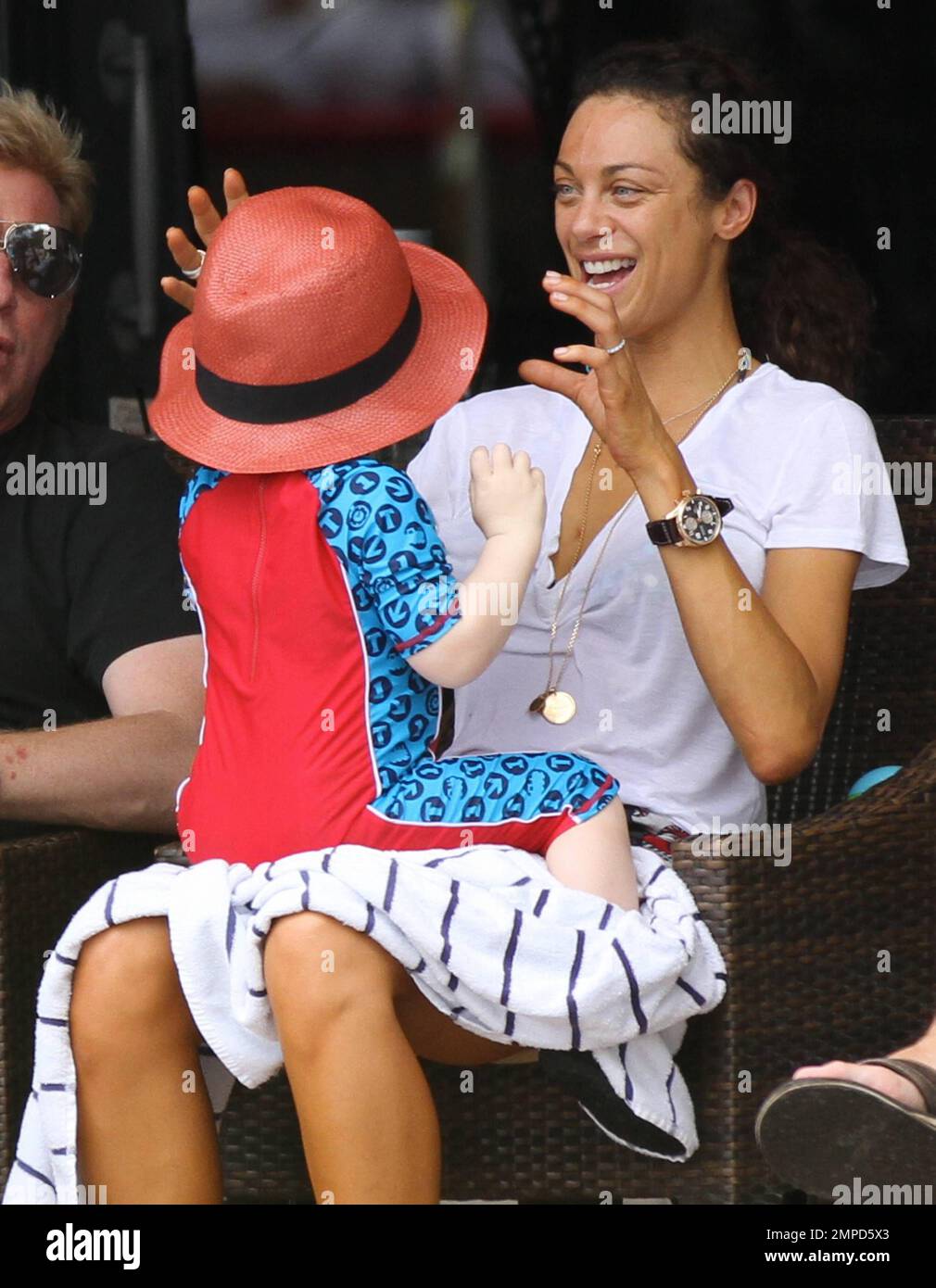 The Becker family lunch at a beachside hotel pool with pals. Boris and ...