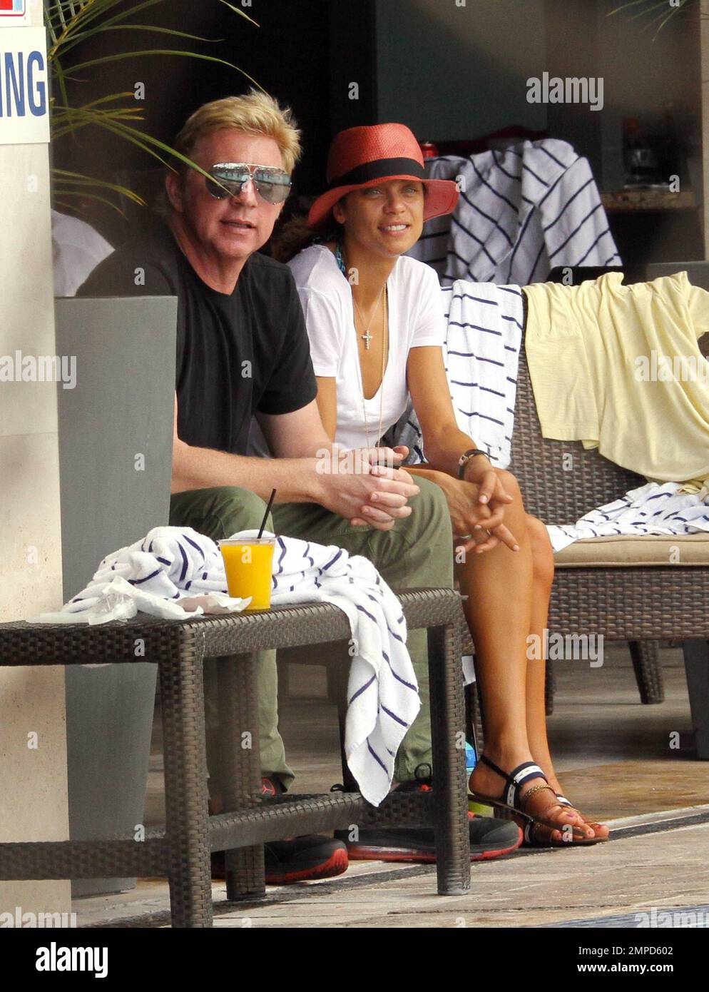 The Becker family lunch at a beachside hotel pool with pals. Boris and ...