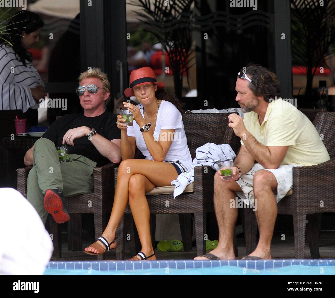 The Becker family lunch at a beachside hotel pool with pals. Boris and ...