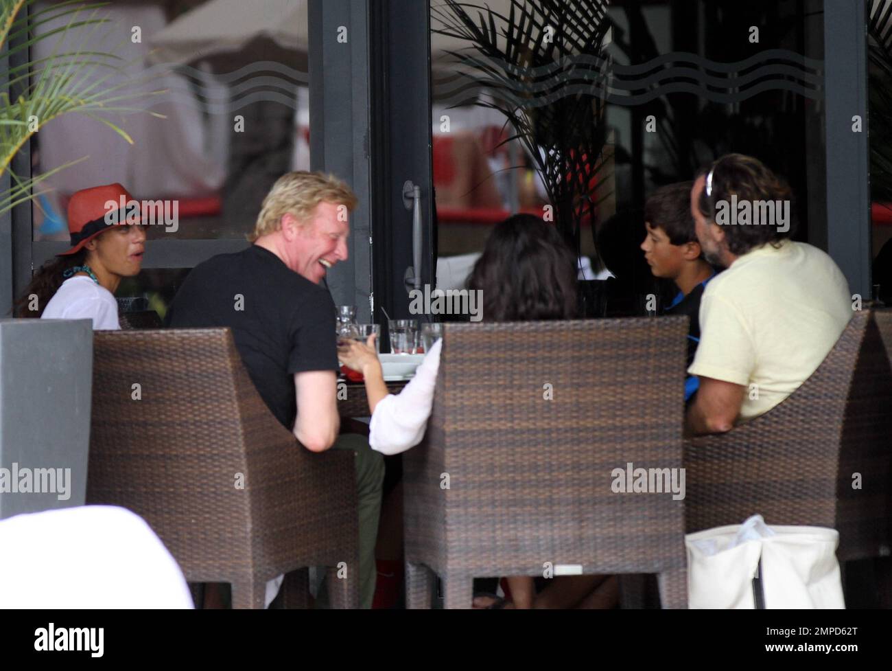 The Becker family lunch at a beachside hotel pool with pals. Boris and ...