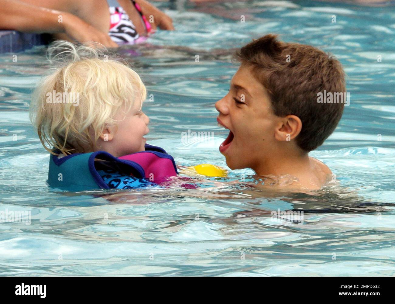 The Becker family lunch at a beachside hotel pool with pals. Boris and ...
