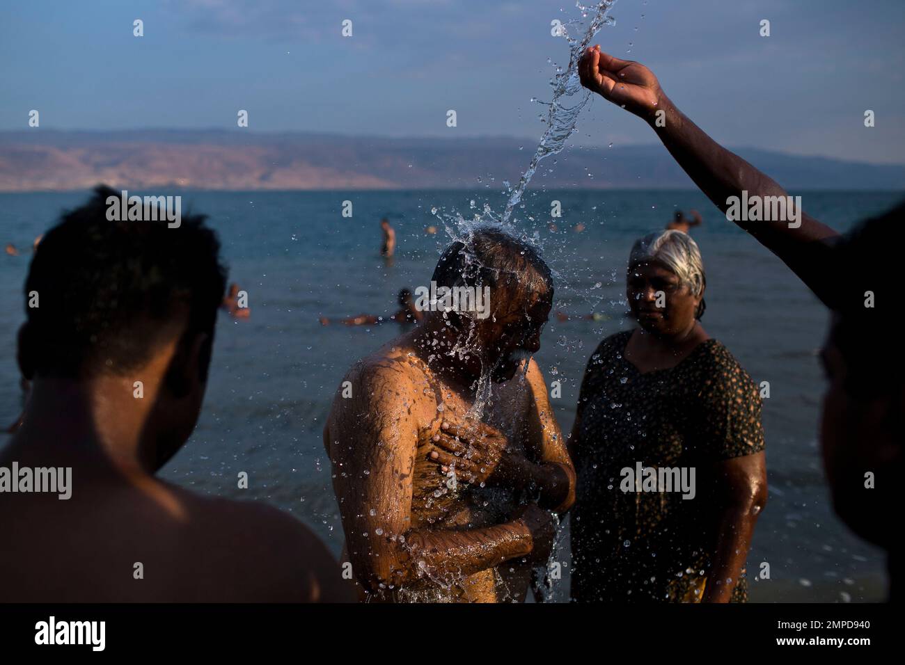 In this Oct. 16, 2017 photo, tourists shower as they enjoy the Dead Sea ...
