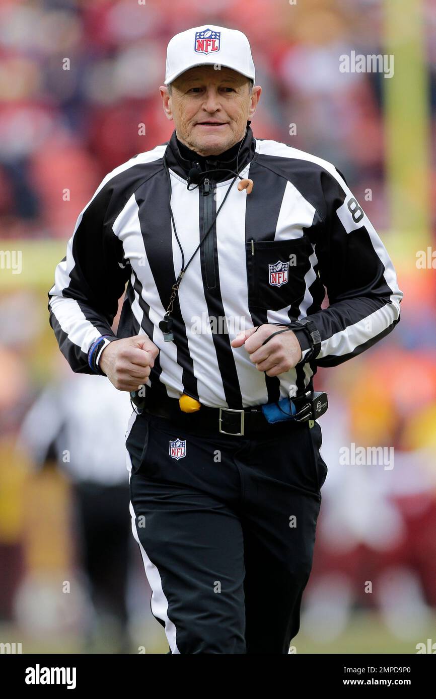 Referee Ed Hochuli runs on the just prior to kick off of an NFL ...
