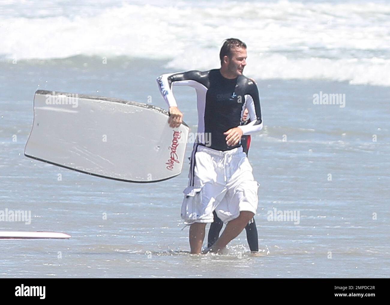 David Beckham and his three sons enjoy another day boogie boarding outside their Malibu home ...