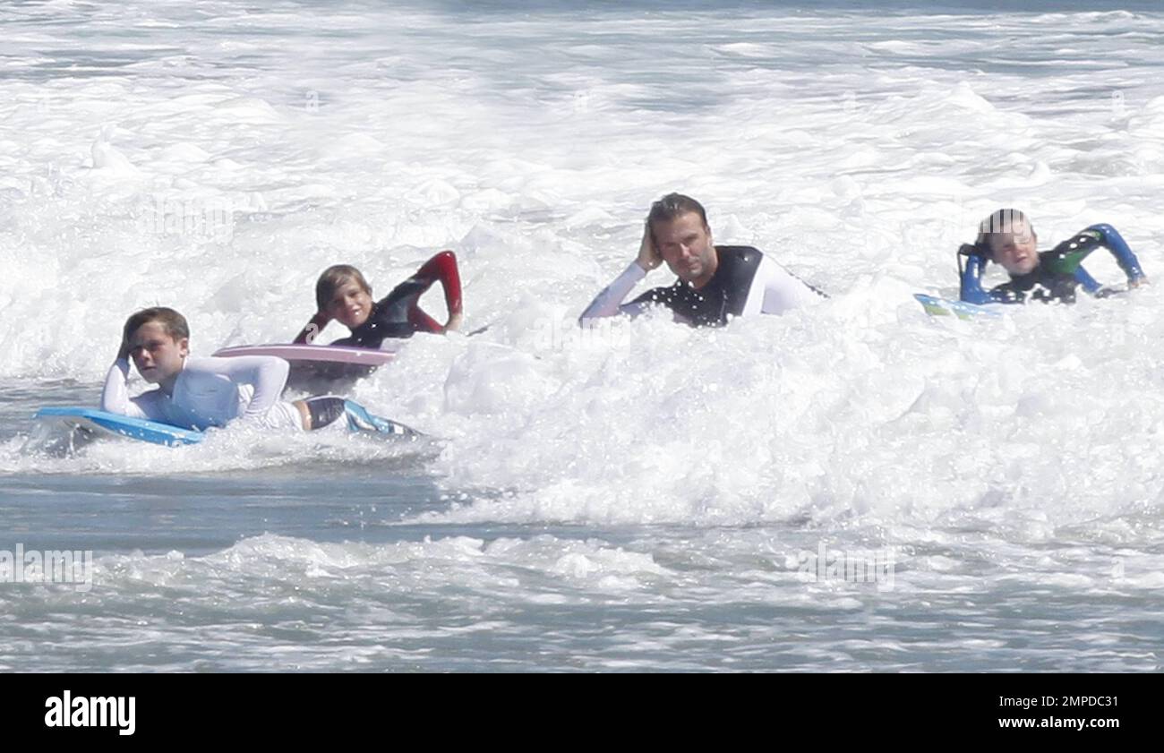 David Beckham and his three sons enjoy another day boogie boarding outside their Malibu home ...