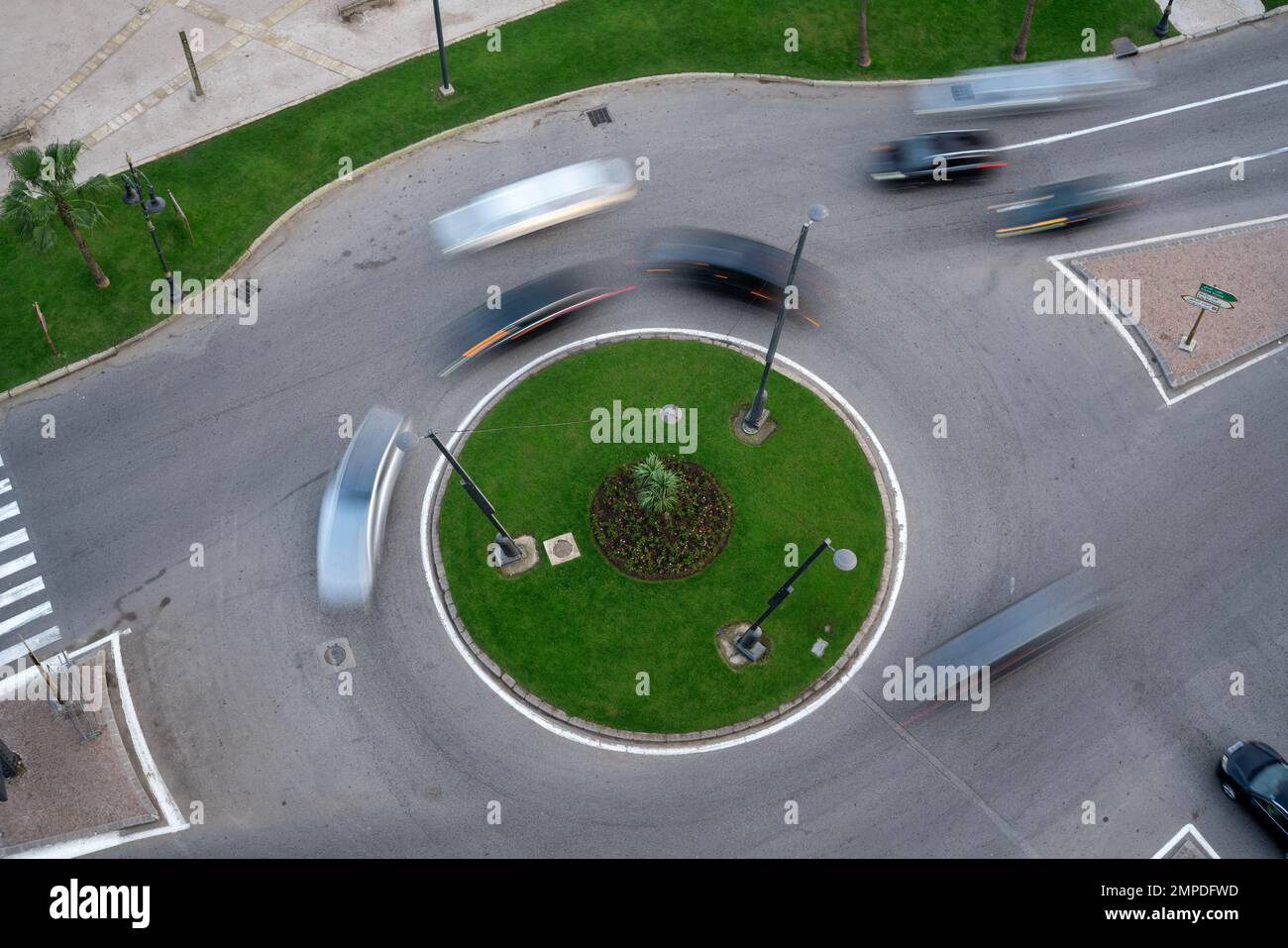 A motion blur of cars driving around a roundabout Stock Photo - Alamy