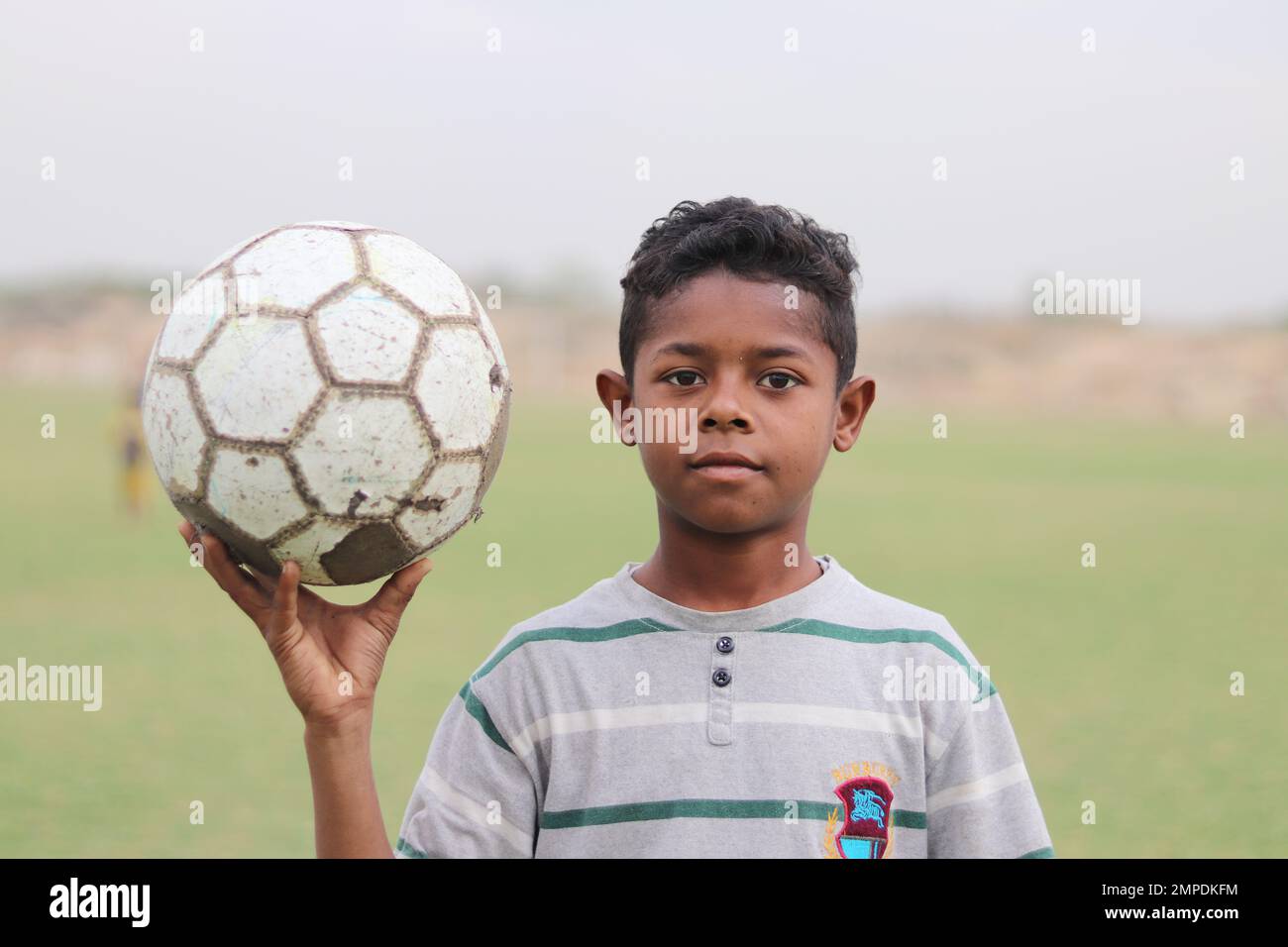 Karachi Pakistan 2019, a kids posing for picture with his blue football ...