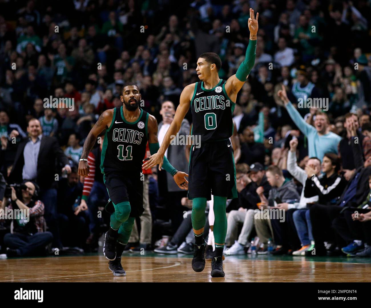 Boston Celtics' Jayson Tatum (0) signals "3" and congratulates teammate ...