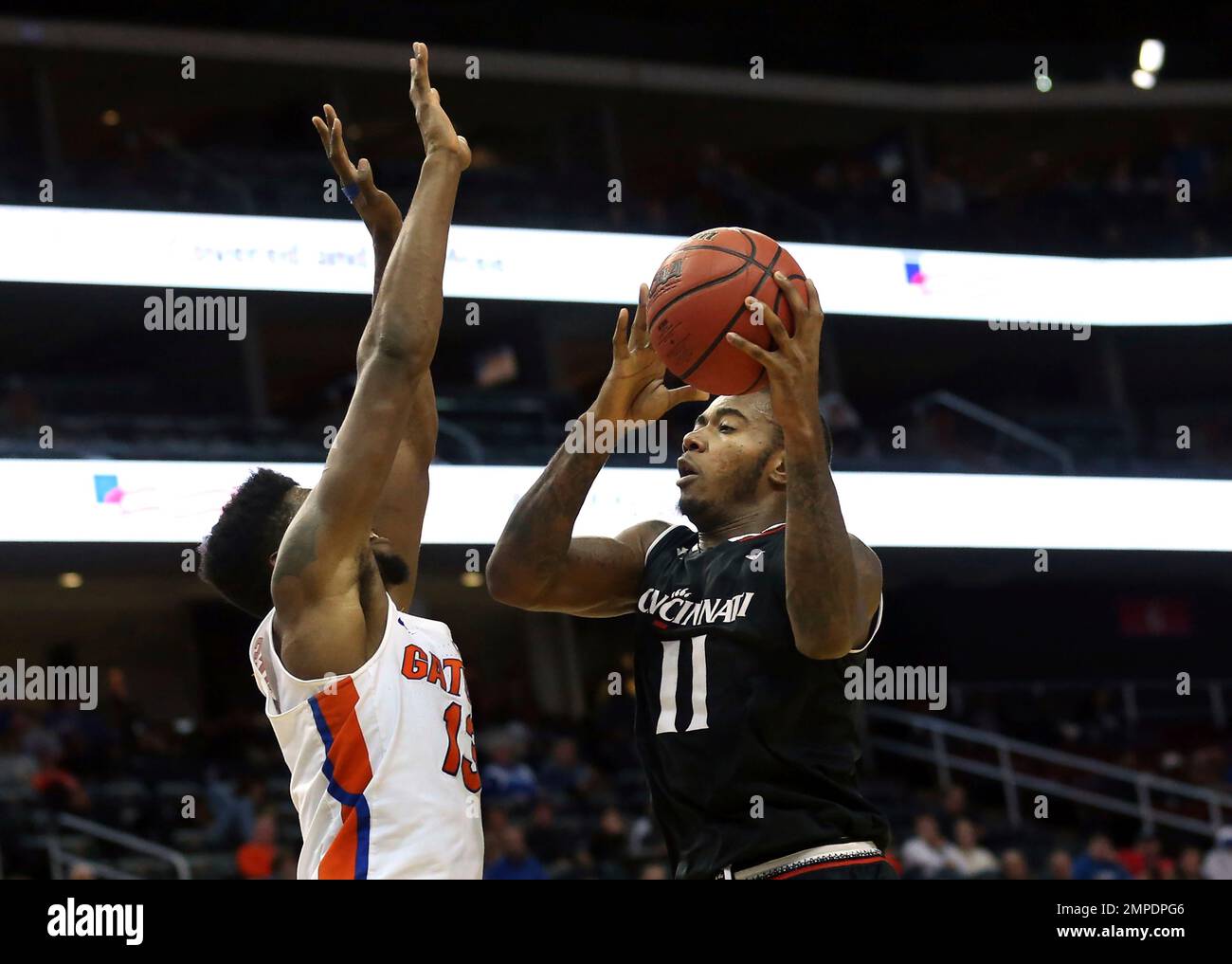 Cincinnati's Gary Clark (11) takes a shot as Florida's Kevarrius Hayes ...
