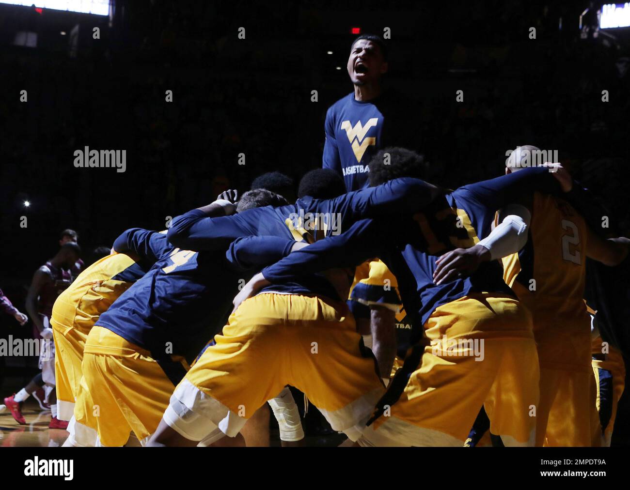 West Virginia guard James Bolden (3) shouts in their pregame huddle ...