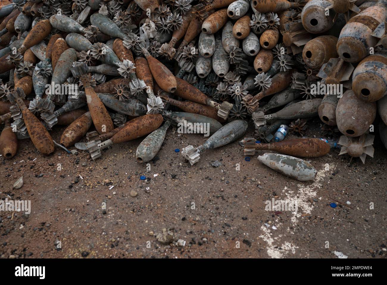 In this Nov. 9, 2017 photo, unexploded mortar shells are gathered on a ...