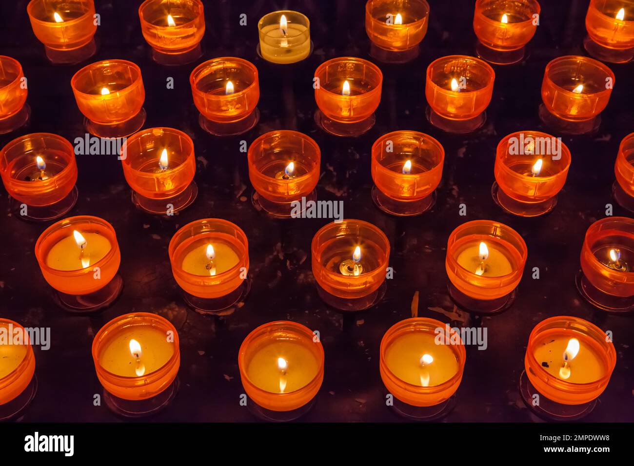 A votive candle rack at a Cathedral Stock Photo - Alamy