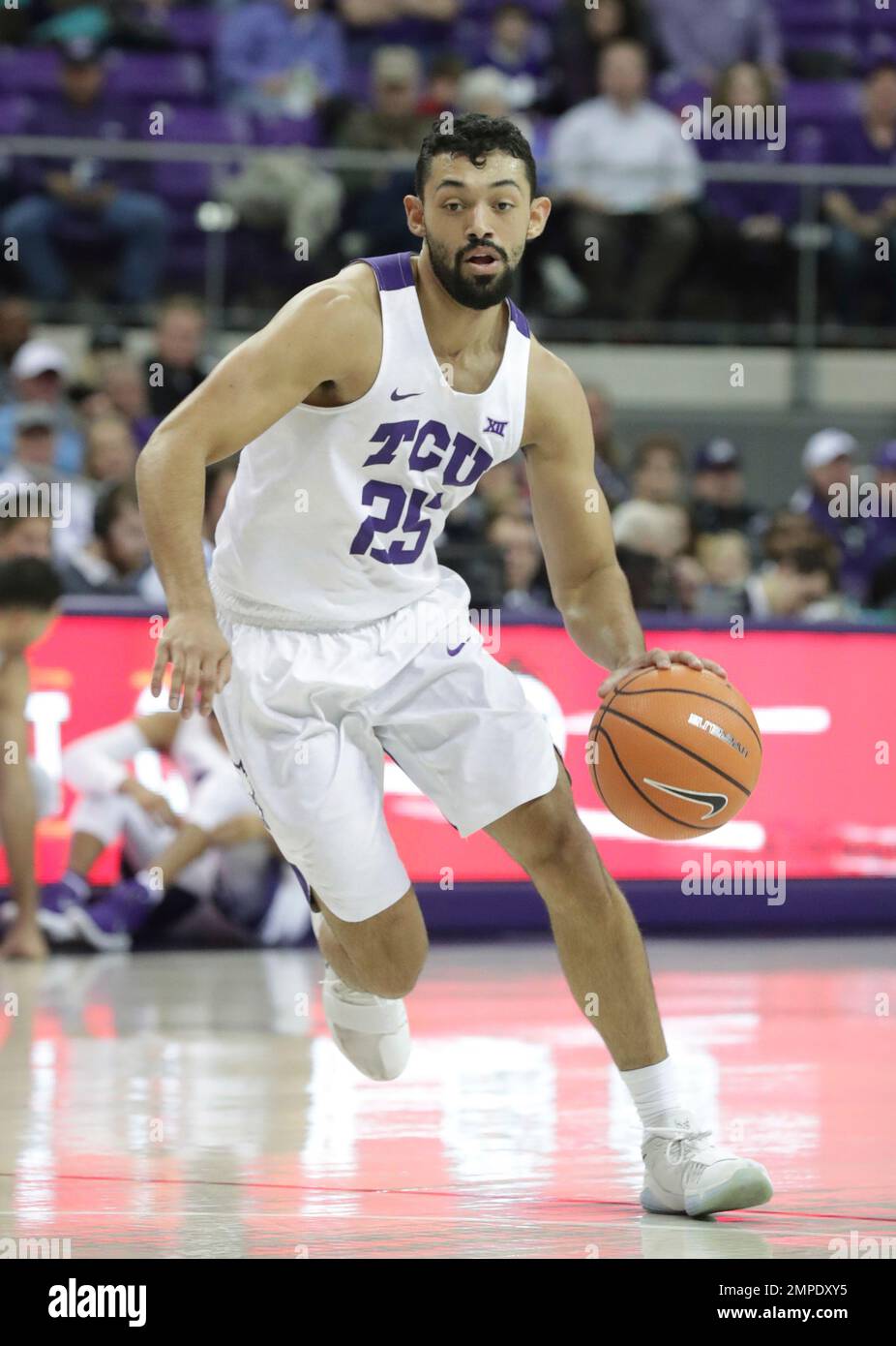 TCU guard Alex Robinson (25) dribbles during the first half of an NCAA ...