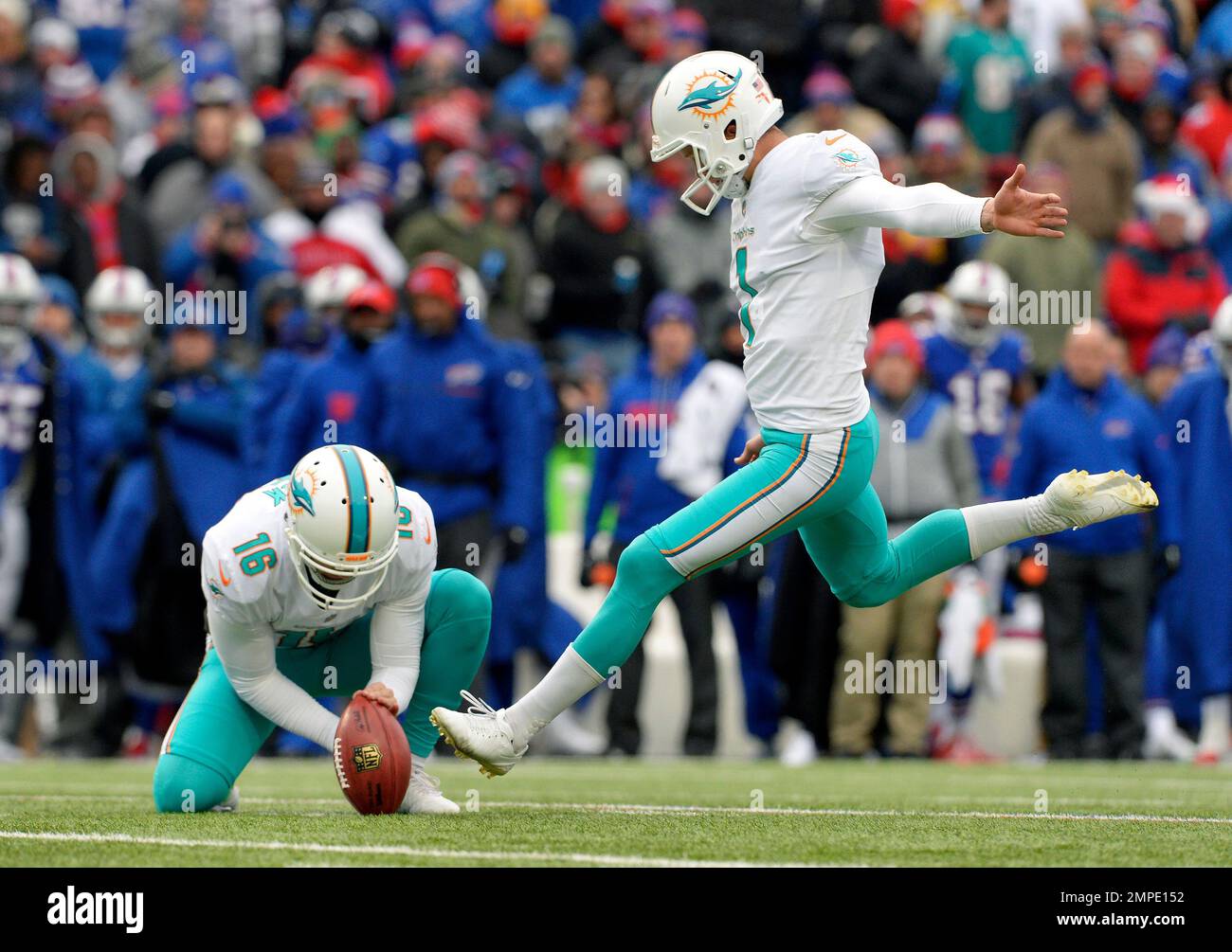Miami Dolphins kicker Cody Parkey (1) winds up for a kick with punter ...