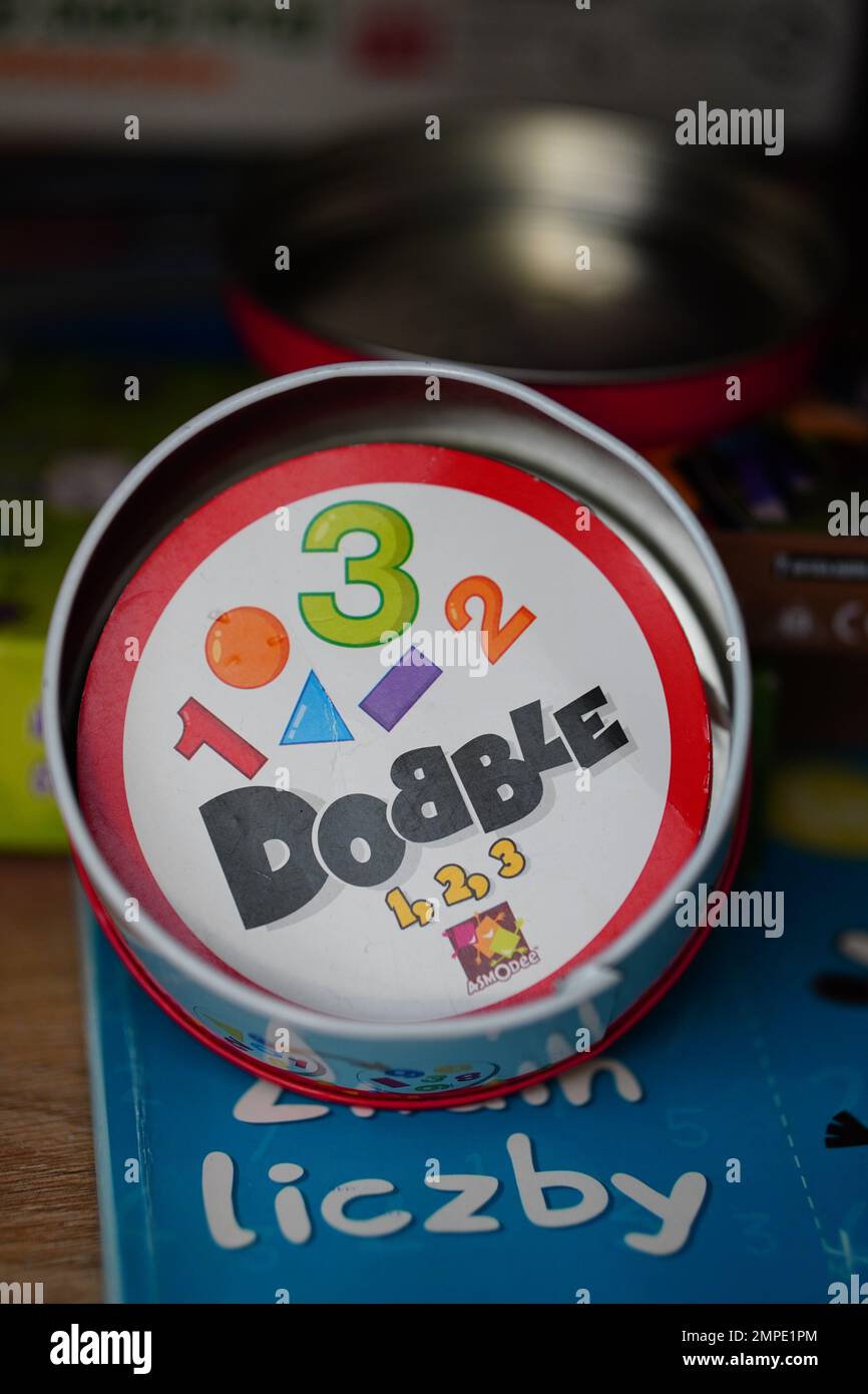 A dobble brand card game with numbers and shapes in a metal box Stock ...