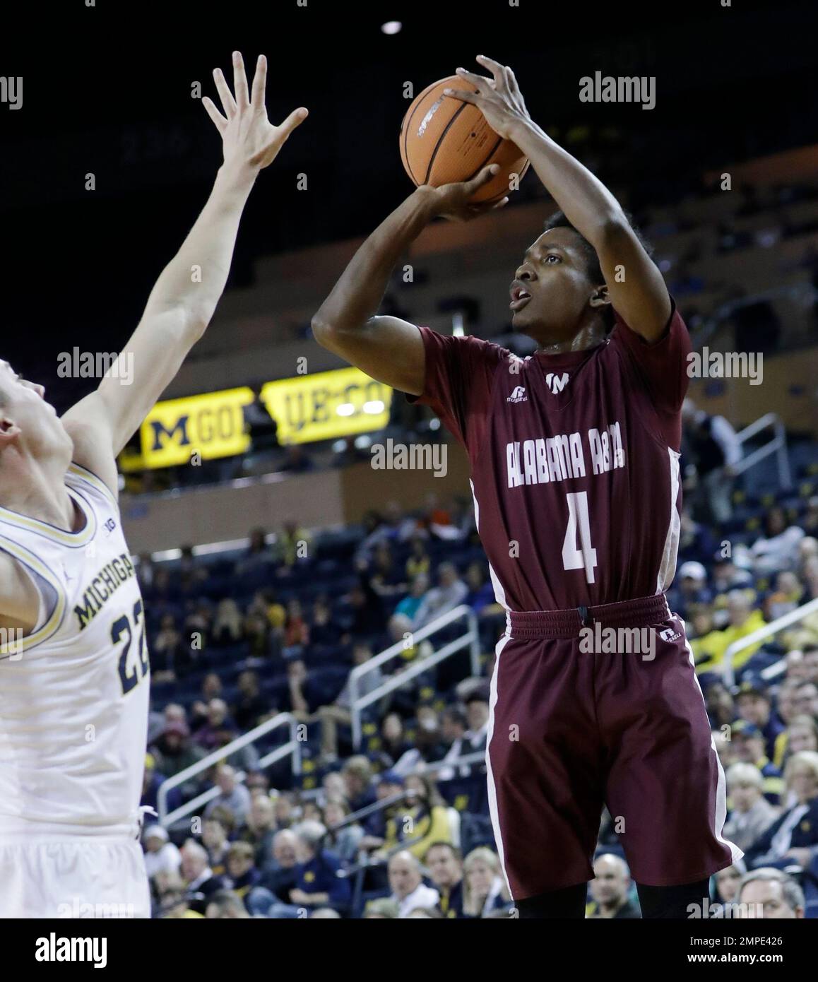 Alabama A&M guard Marcus Merriweather (4) shoots over Michigan guard ...