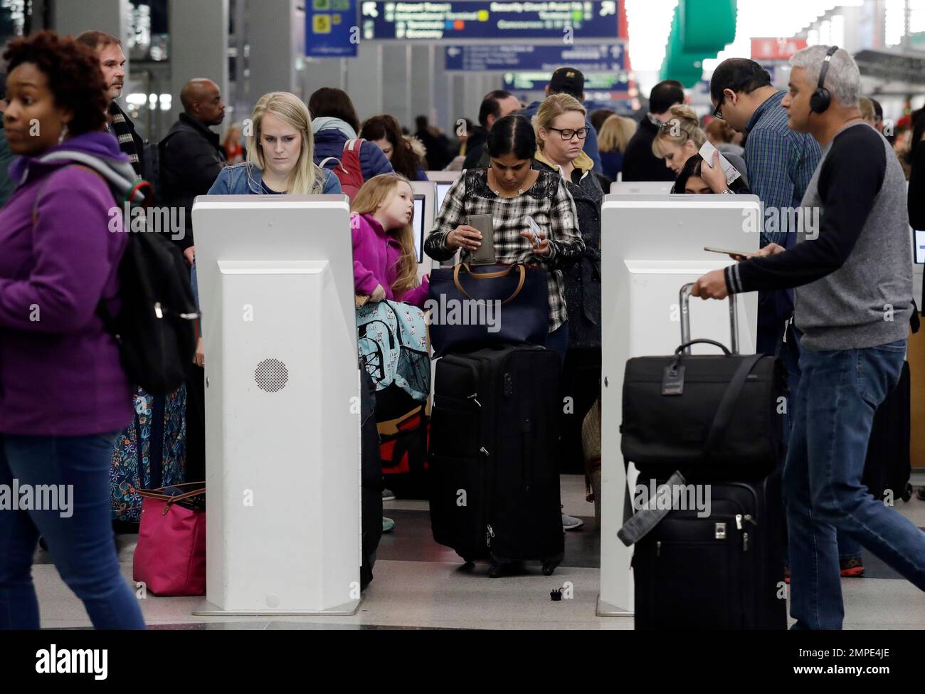Travelers check in at the American Airlines self ticket counter at O ...
