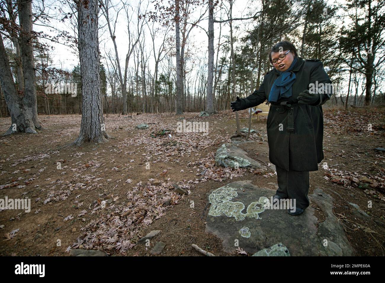 Pastor Michelle Thomas stands on what is known as the "preachers rock ...
