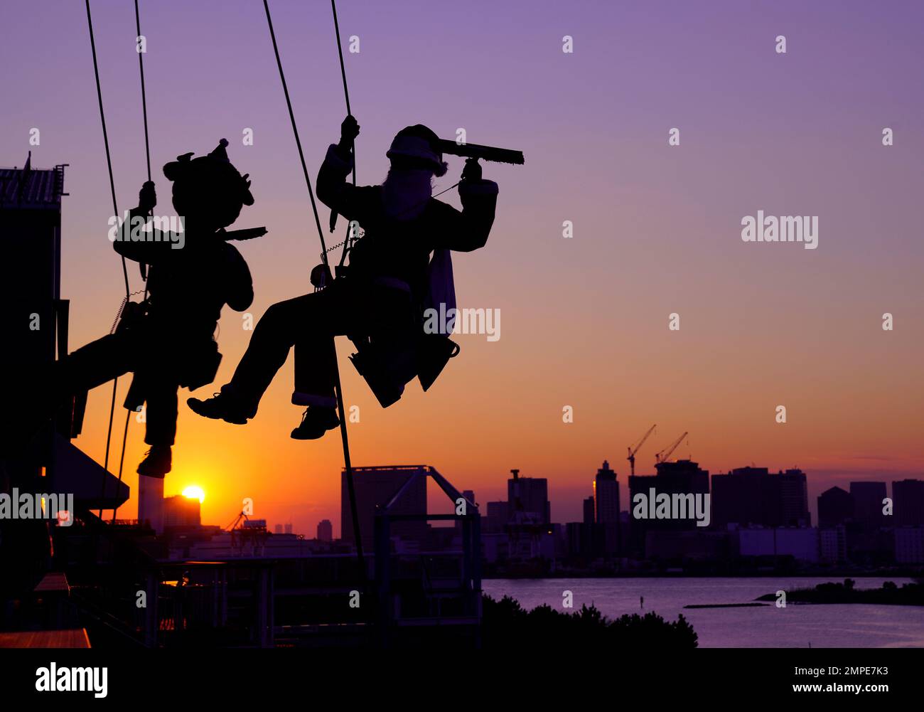 Window cleaners dressed as Santa Claus and a reindeer pose for ...