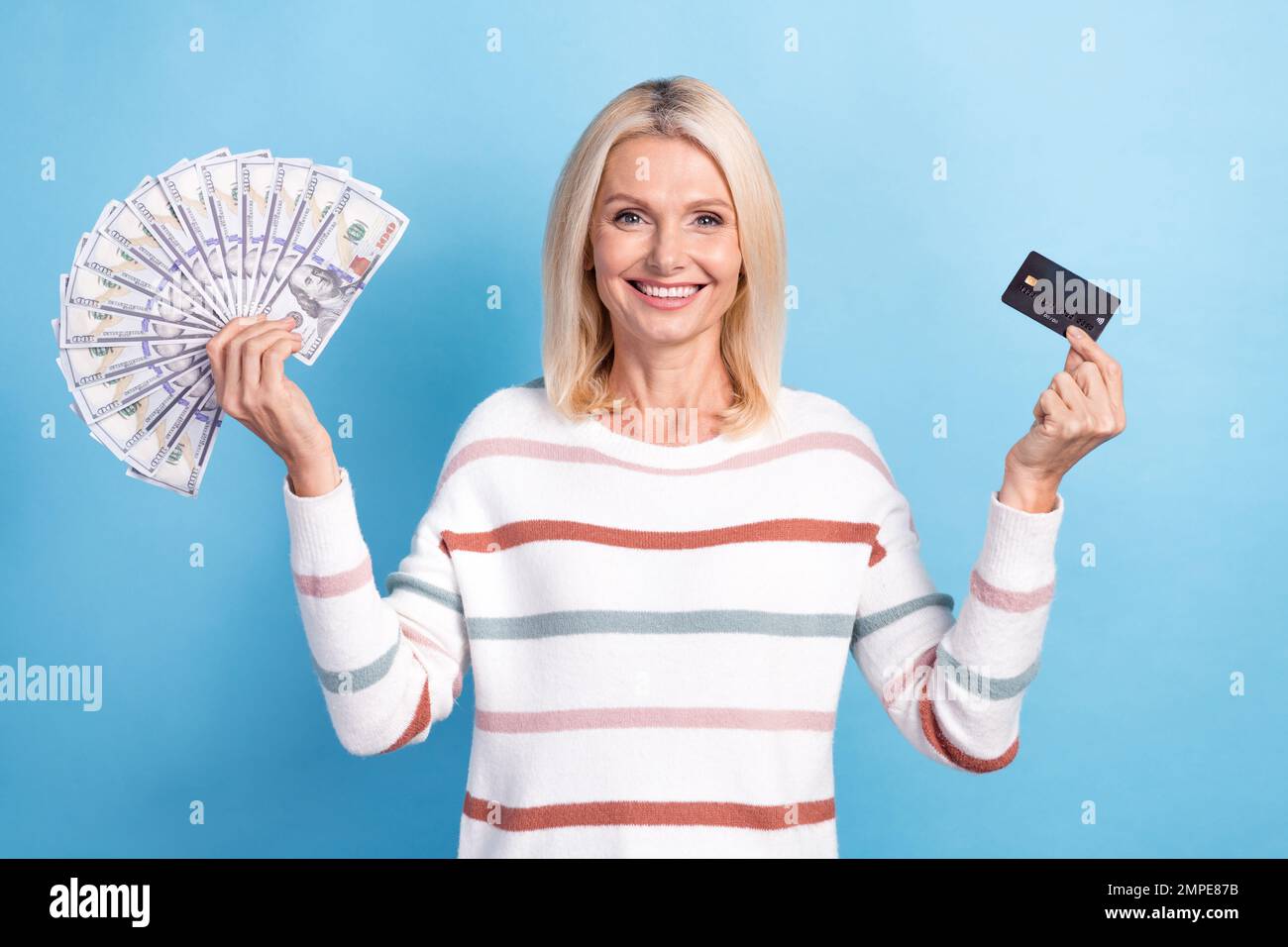 Photo of pretty sweet lady wear striped pullover holding money fan ...