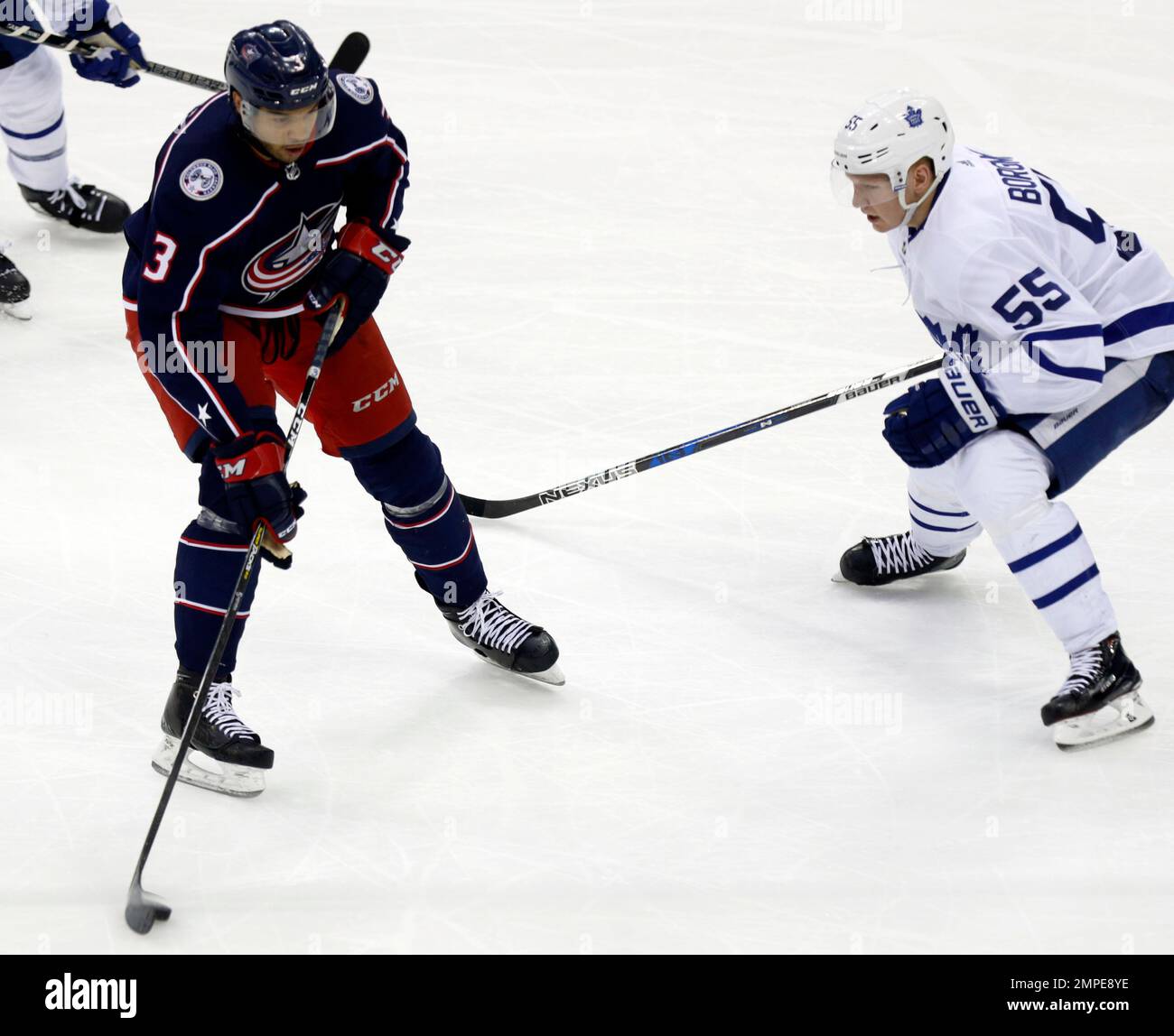 Columbus Blue Jackets defenseman Seth Jones, left, controls the puck ...