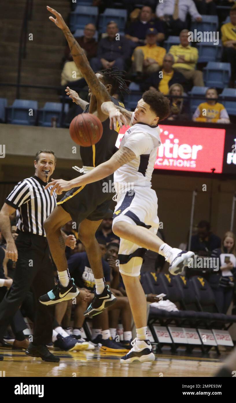West Virginia forward Teddy Allen, right, steals the ball from Coppin ...