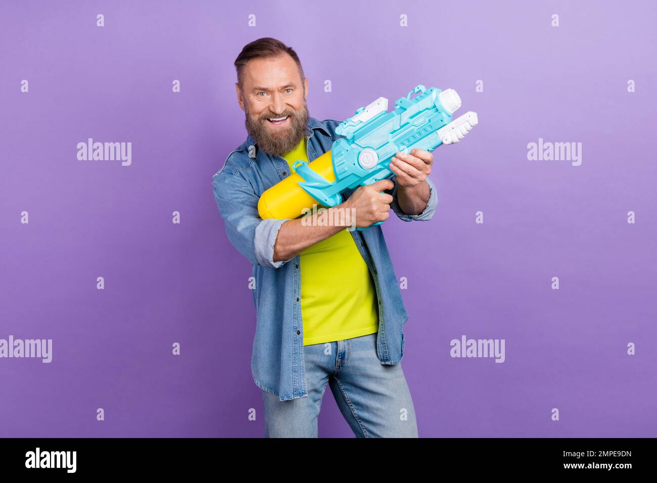 Photo of cheerful granddad arms hold water gun have good mood isolated ...