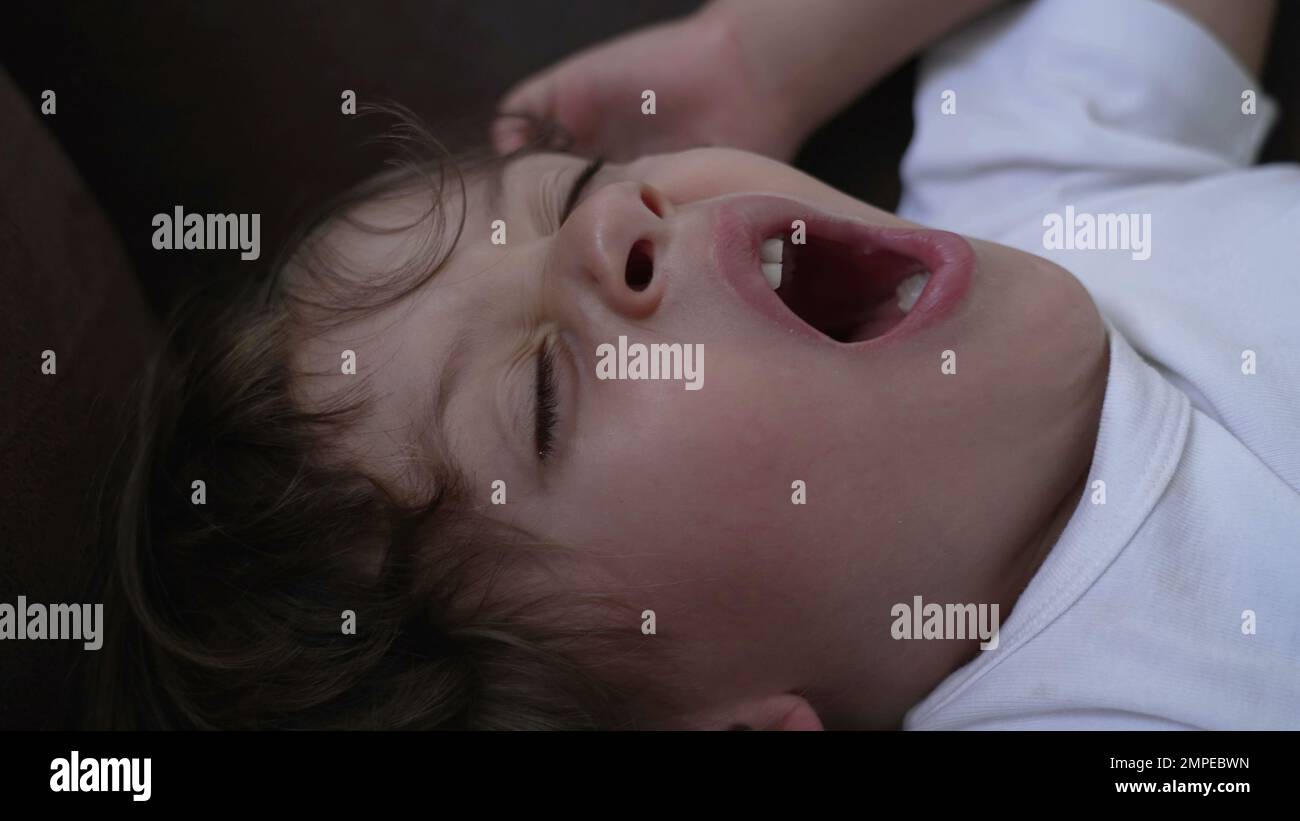 Small boy yawning falling asleep. Child close up face portrait sleeping ...