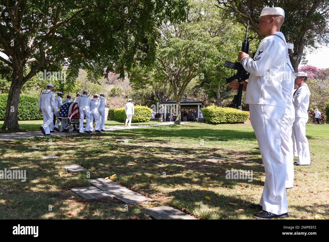 U.S. Navy Sailors assigned to Navy Region Hawaii carry a casket holding ...
