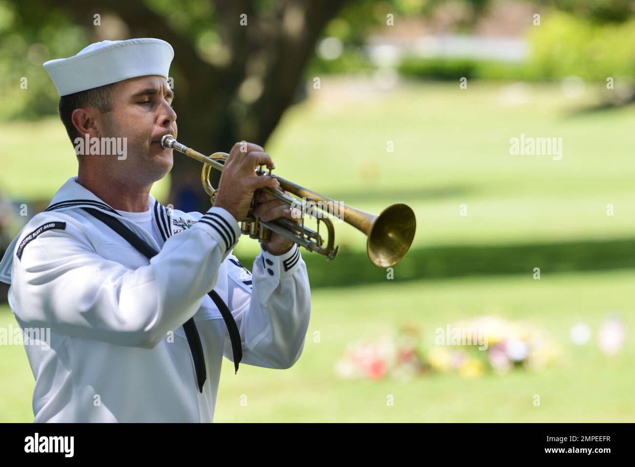 A U.S. Navy Sailor plays taps during an interment ceremony for U.S ...