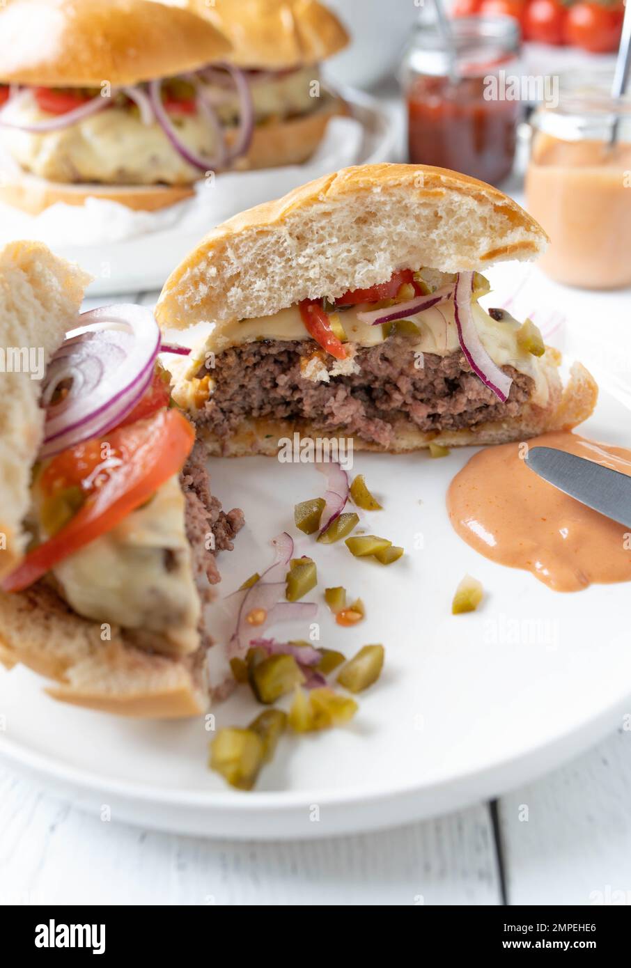 Homemade hamburger, cheeseburger or burger cut in half on a plate with ...