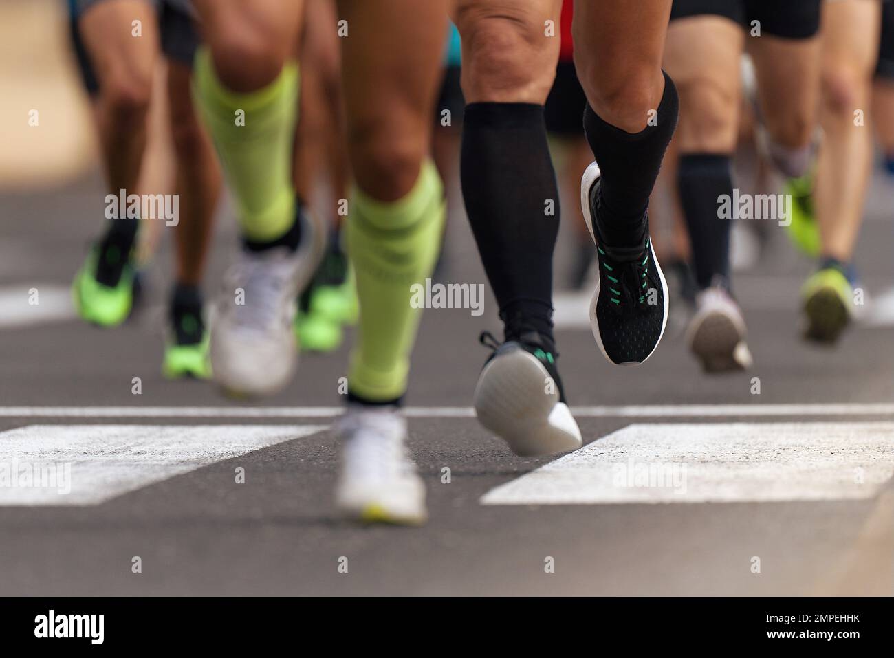 Marathon running race, people feet on city road Stock Photo - Alamy