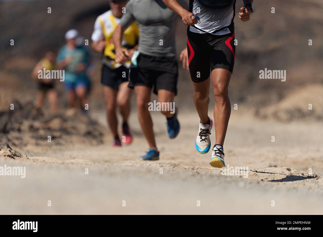Runners running shoes on trail run. Ultra running athletes legs close ...