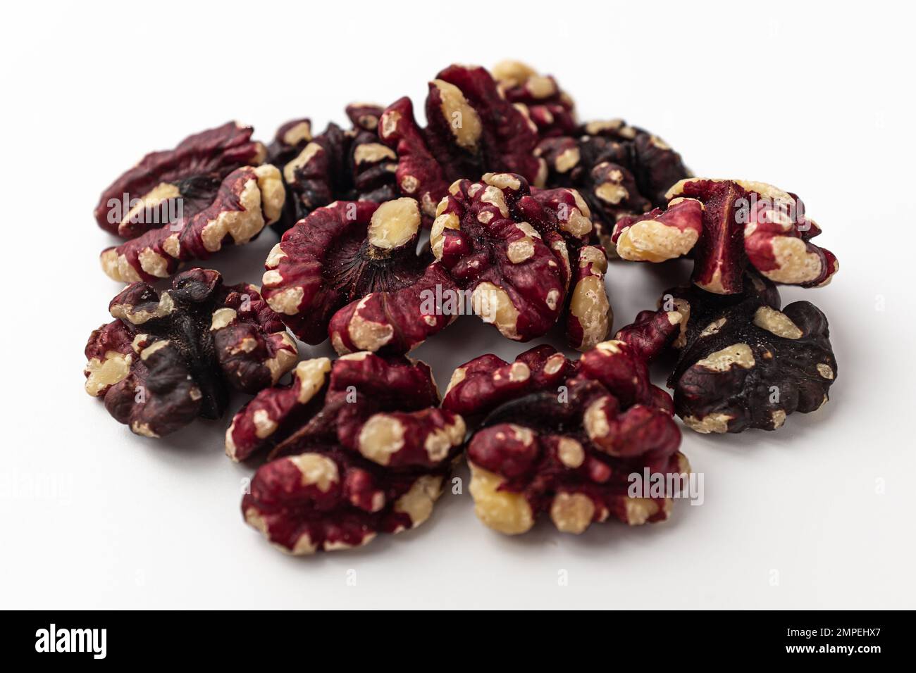 Red walnuts on a white background Stock Photo - Alamy