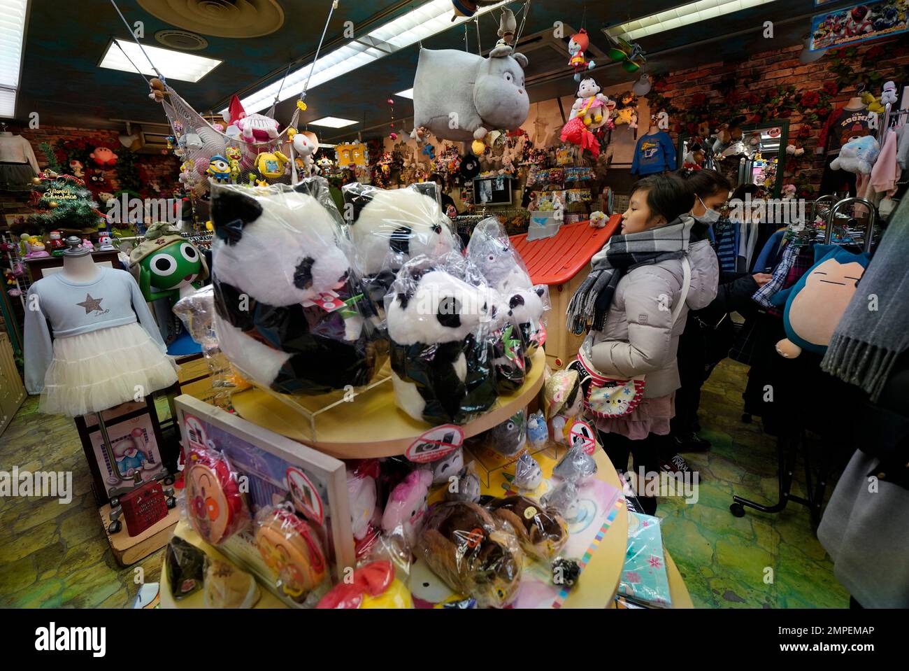 In this Sunday, Dec. 17, 2017, photo, customers look around panda goods ...