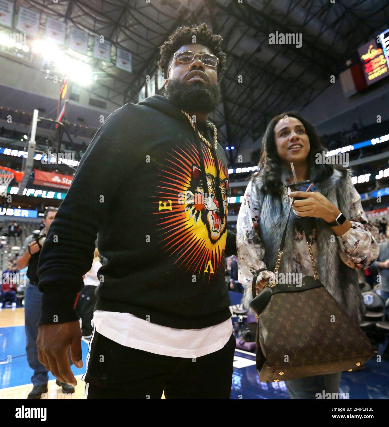 Dallas Cowboys running back Ezekiel Elliott, left, walks with his ...