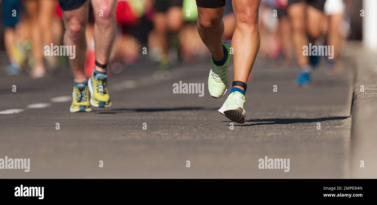 Marathon running race, people feet on city road Stock Photo - Alamy