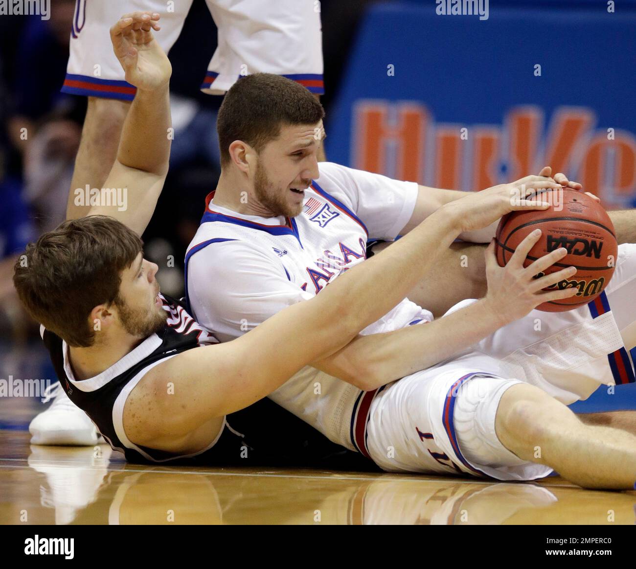Kansas guard Sviatoslav Mykhailiuk, right, holds the ball away from ...