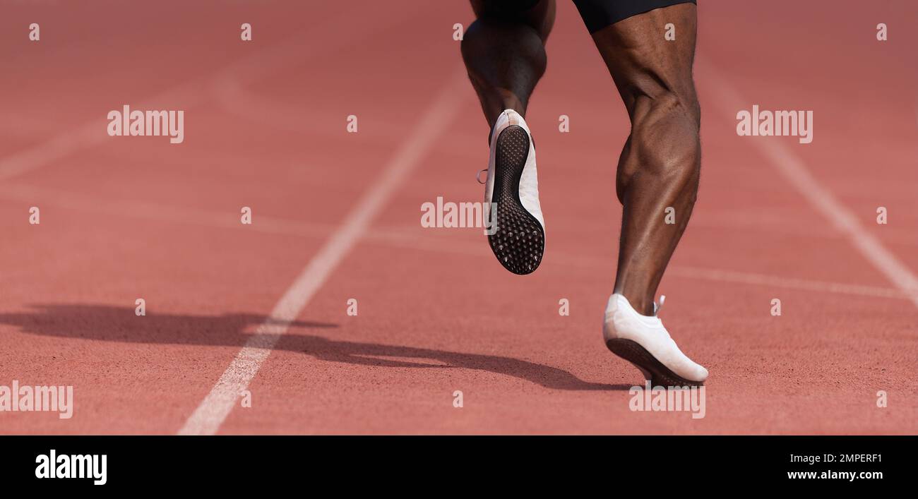 African-american male sportsman running on stadium track, dynamic run ...