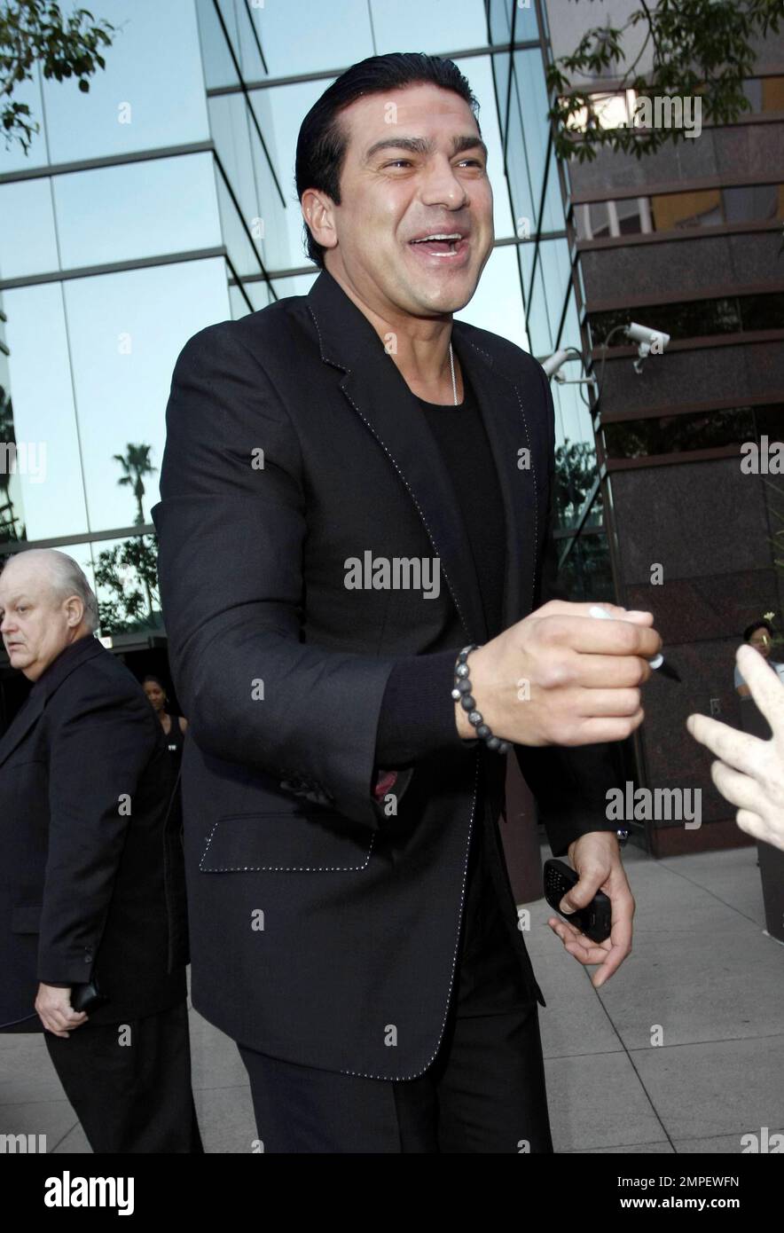 Actor Tamer Hassan smokes a cigarette as he signs autographs at the ...
