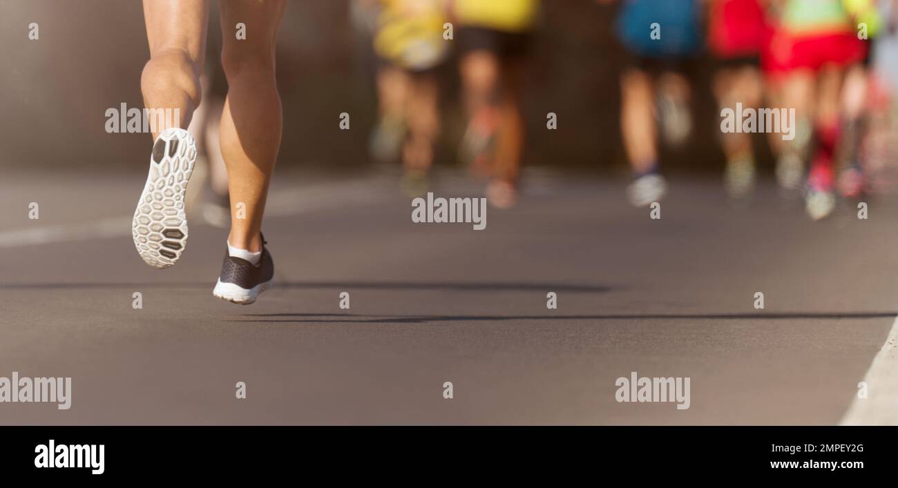 Marathon running in the light of evening, detail on legs Stock Photo ...