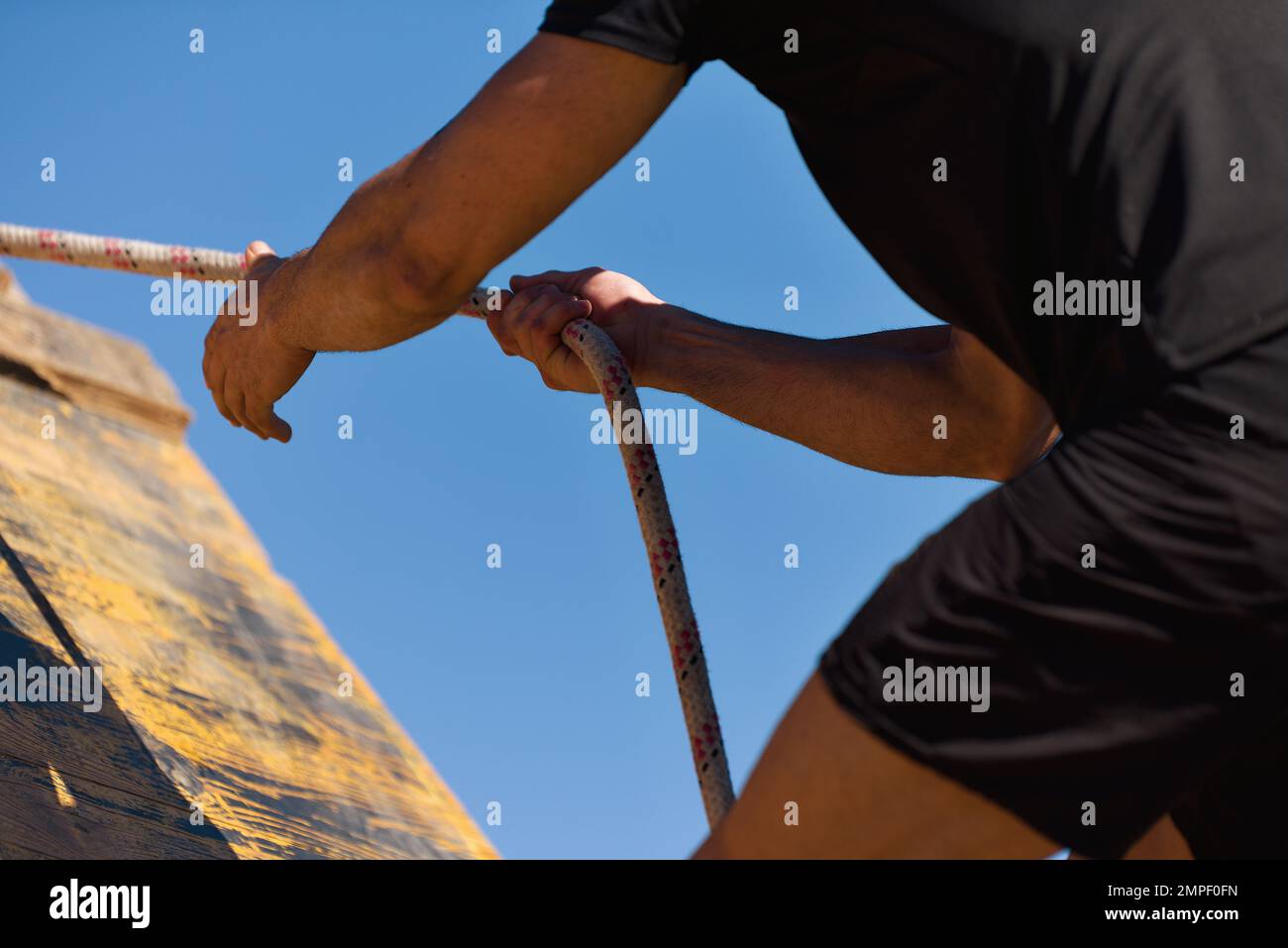 Mud race runners,participant for overcoming barriers through rope Stock ...