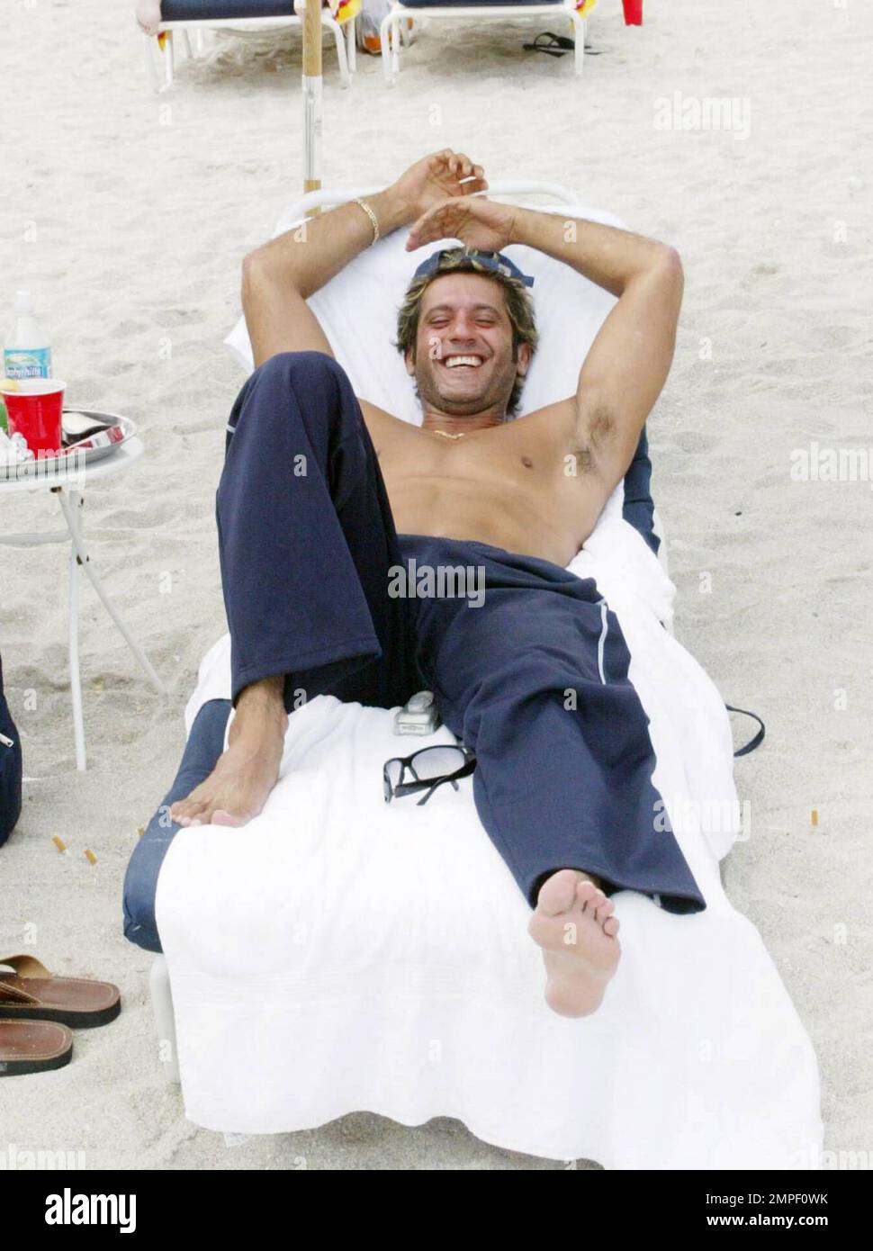 Mexican actor Bobby Larios relaxes in the sun on Miami Beach following ...