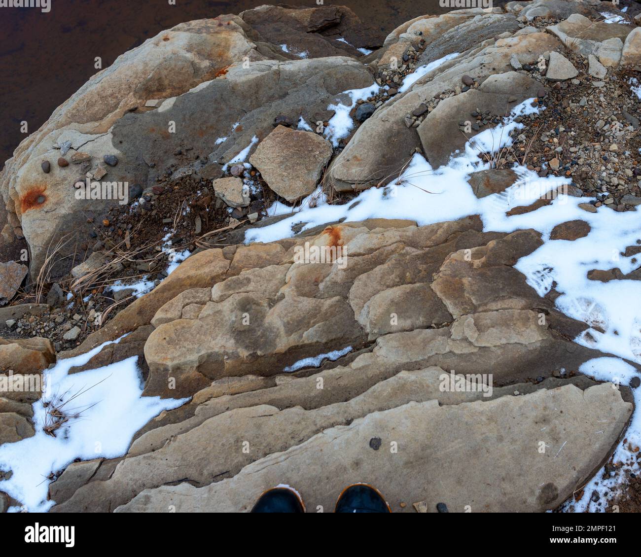 Abstract photo of a rocky rock on the shore with dark transparent water ...