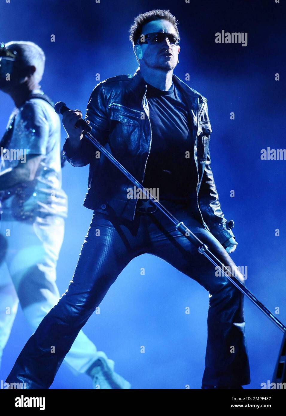 Veteran rock star Bono (aka Paul Hewson) wears tight black leather pants as he performs live in ...