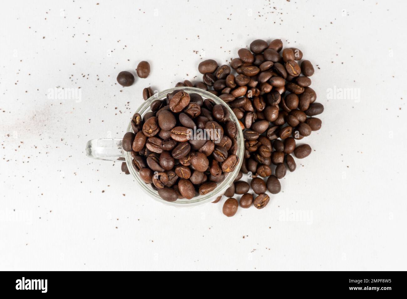 Coffee Beans Spilling Over White Background And Coffee Cup Filled With ...