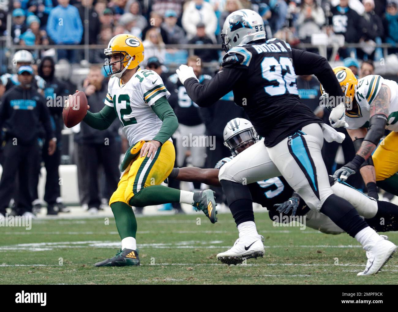 Green Bay Packers' Aaron Rodgers (12) scrambles past Carolina Panthers ...